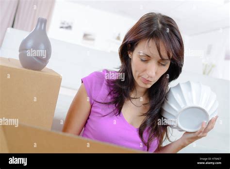Woman Securing Her Fragile Objects In The Box Before Moving Stock Photo Alamy