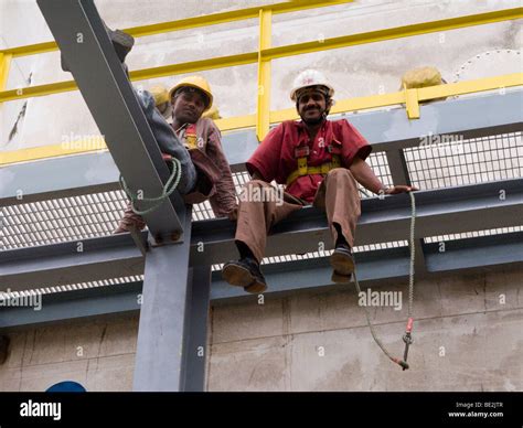 Indian Construction Workers Assembling A Factory Building In An