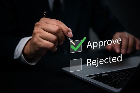 Hand With A Pen Marking Approval On A Digital Checkbox Laptop