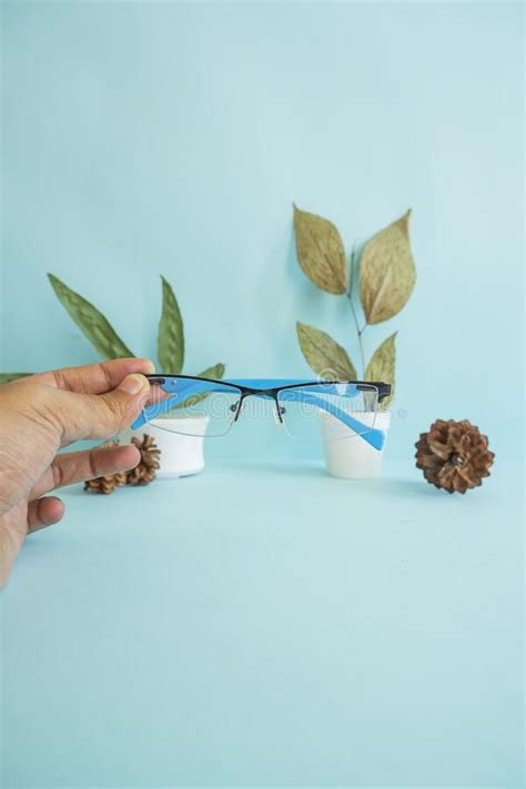 Vertical Photo Glasses Hands Pine Flowers And Green Leaves On Pink Paper Background Stock