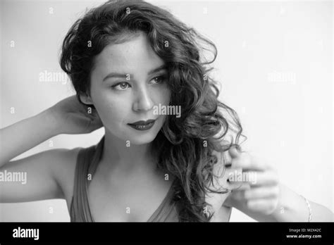 Beautiful Classically Dressed Young Girl Dances Across A Grey Backdrop