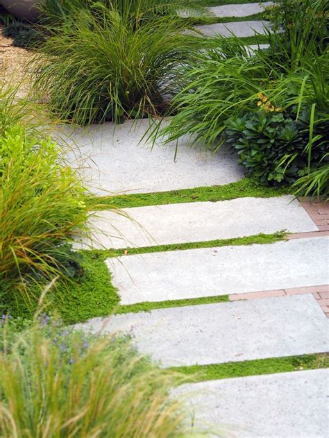 Beautiful Outdoor Walkway With Lush Grass And Colorful Flowers Yard
