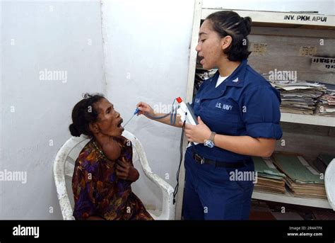 Us Navy Hospital Corpsman Third Class Takes The Temperature Of An