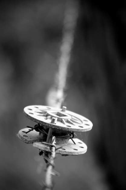 Premium Photo Close Up Of Spool On Barbed Wire Fence