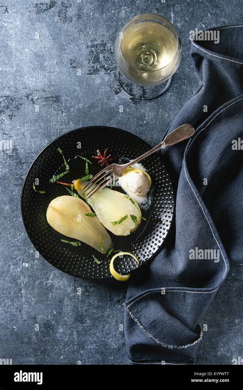 Traditional Dessert Sliced Poached Pears In White Wine Served In Black