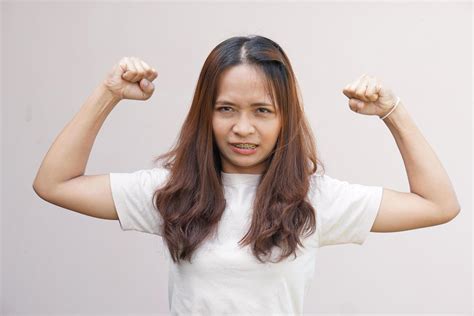 Asian Women Flex Their Muscles And Show Their Strength 17521431 Stock