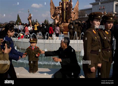 North Korean Soldiers And Civilians Pose For Souvenir Photos In Front