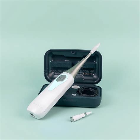 A Modern Dental Curing Light With Its Case On A Pastel Mint Background Stock Illustration