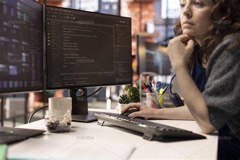 Female Programmer Seen Typing Code For A User Interface Design On Dual