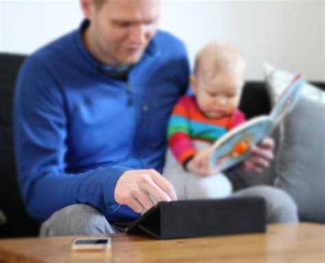 Premium Photo Father And Daughter Sitting On Sofa At Home