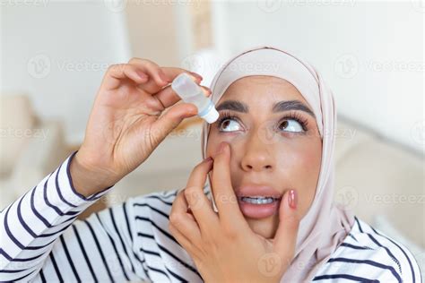 Arabic Woman With Hijab Using Eye Drop Dropping Eye Lubricant To Treat