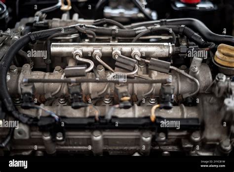 Detailed View Of Fuel Injectors And Engine Components Showcasing The Complexity Of A Modern Car