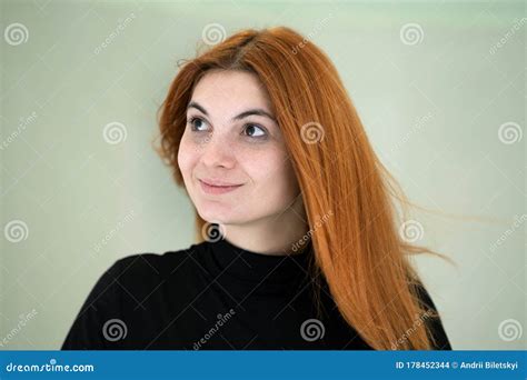 Close Up Portrait Of Pretty Redhead Girl With Long Wavy Hair Blowing On