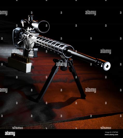 Sniper Rifle With Orange Light From The Side With A Bipod Mounted And