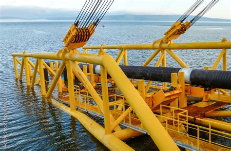 Laying Of Pipes With Pipe Laying Barge Crane Near The Shore Descent Of