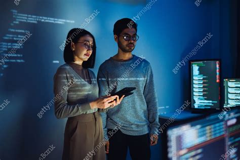 Asian Two Software Developers Engaged In Collaborative Coding Session