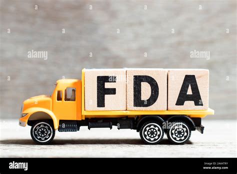 Truck Hold Letter Block In Word Fda Abbreviation Of Food And Drug