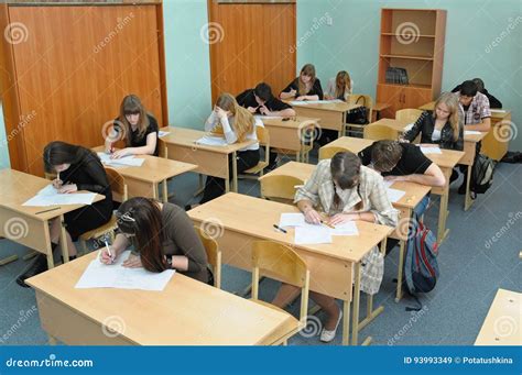 School Exam Room With Teacher Invigilator Monitoring Students Taking
