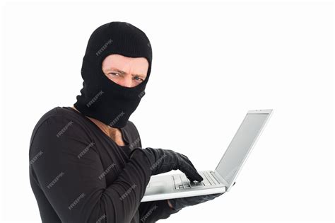 premium photo hacker using laptop to steal identity