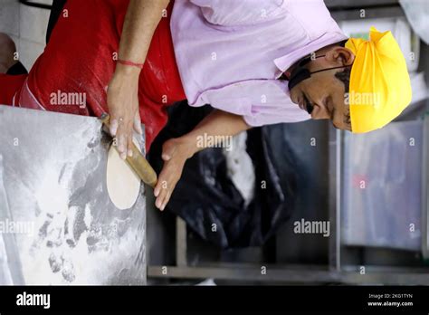Hindu Man Preparing Indian Flat Bread Chapathi From Wheat Dough Shiva