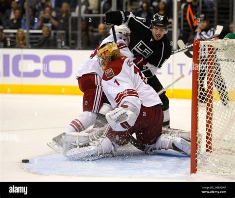 Los Angeles Kings Center Mike Richards Right Tries To Get A Shot In On Phoenix Coyotes Goalie