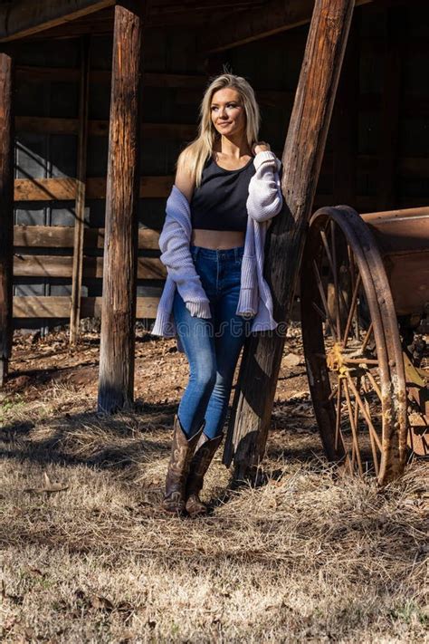 Lovely Blonde Model In Western Gear Poses Outdoor While Enjoying The