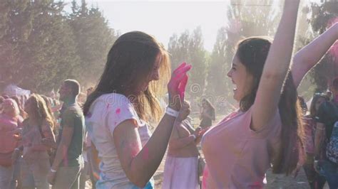 Drunk Girls Having Fun At Openair Festival Kissing In Clouds Of Colorful Powder Stock Video