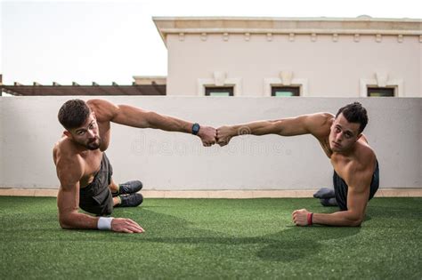 Two Handsome Shirtless Men Giving Fist Bump After Successful Workout At
