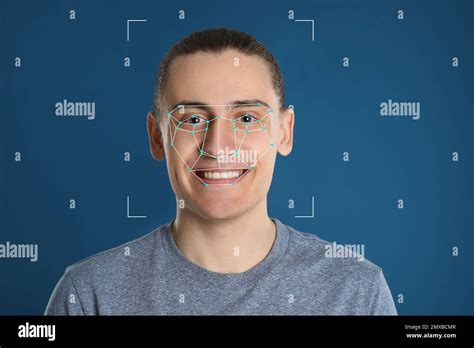 Facial Recognition System Man With Scanner Frame And Digital Biometric Grid On Blue Background