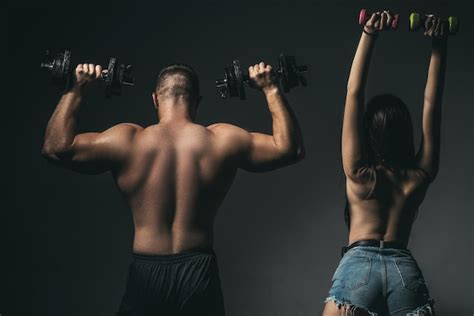 Premium Photo Couple Exercising With Dumbbells Together Muscular Man