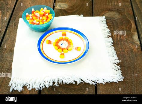 Pieces Of Halloween Candy Corn Arranged In A Circle On A Color