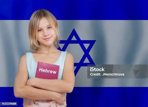 Cute Blonde Teen Girl Embracing Book With Inscription Hebrew In Hebrew