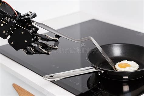 Real Robot Hand And Frying Pan With Fried Egg Concepts Of Ai
