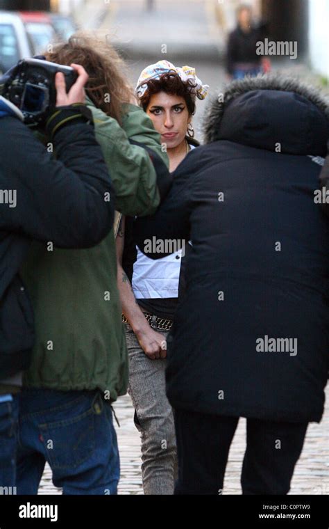Amy Winehouse Surrounded By Paparazzi As She Returns Home From The Pub With Friends London