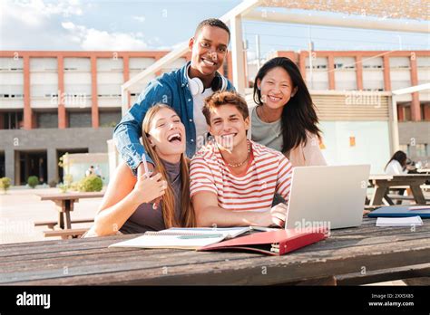 Diverse Group Of Male And Female Students Smiling And Looking At