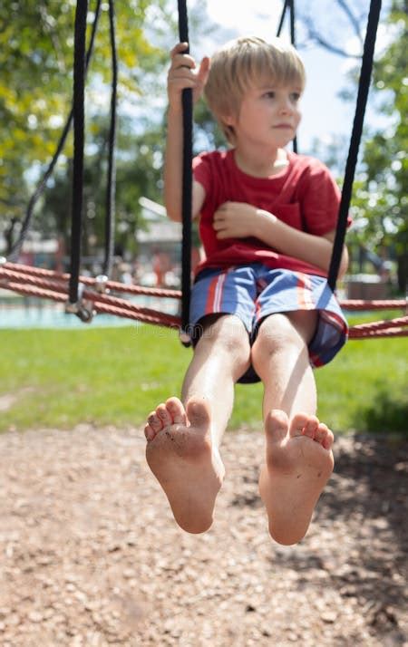 Barefoot Boy 6 7 Years Old Sits On A Sports Net In A Park On A