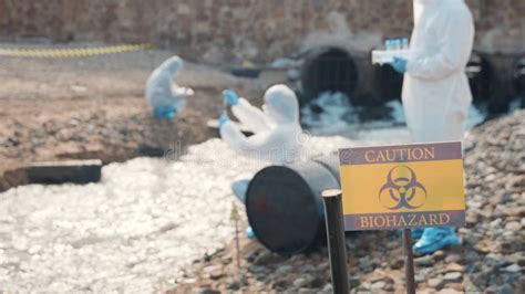 Closeup Of Chemical Warning Sign Ecologist Sampling Water From The