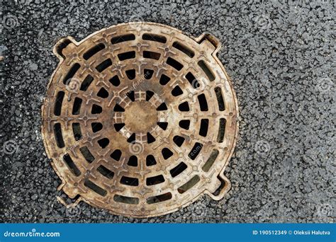 Closed Sewer Manhole Which Is Located On The Sidewalk Stock Image