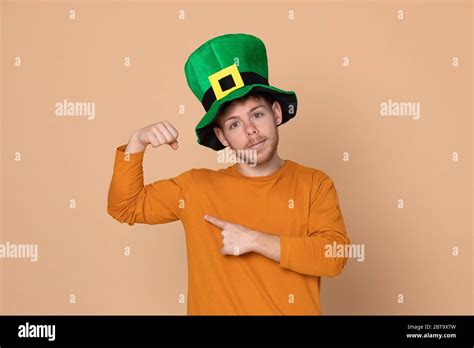 Attractive Young Guy With A Big Green Hat On A Yellow Background Stock