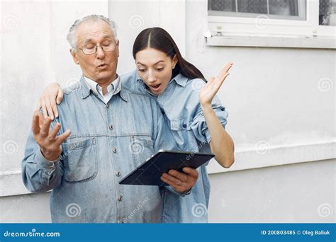 Girl Teaching Her Grandfather How To Use A Tablet Stock Image Image