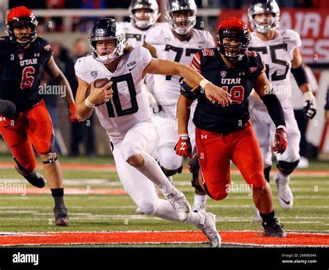 Oregon Quarterback Justin Herbert 10 Carries The Ball As He Is Pursued By Utahs Bradlee Anae