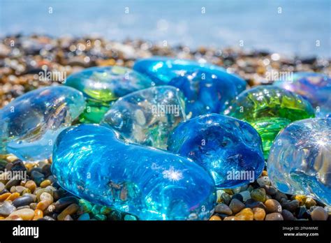 Beautiful Shape Glass And Stones On The Seashore Azure Clear Sea Water