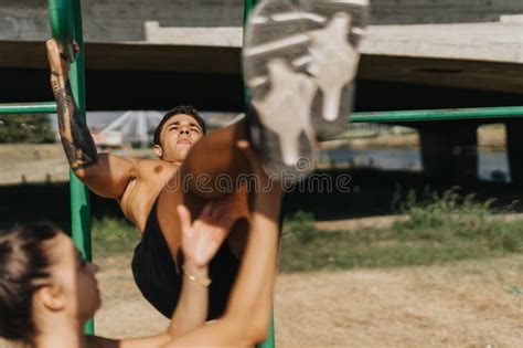 Friends Challenge Each Other With Pull Ups In The Park For Outdoor