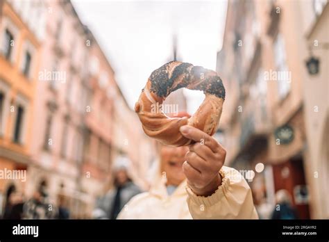 Senior Woman Holding Prezel Traditional Polish Snack On The Market