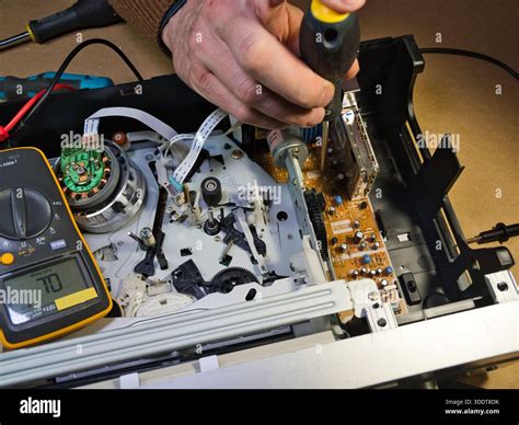 Vcr Repair And Maintenance With Vhs Tape Overhead View Of A Technician