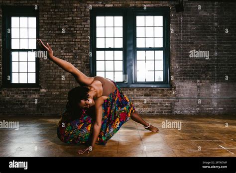 Dancer Does Dancing Movement Inside Building With Exposed Brick Stock