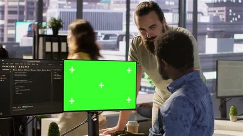 System Administrator Does Software Debugging On Green Screen Pc With Colleague Business