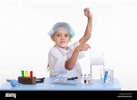 Chemist Girl Sitting At The Table With The Reagents In Chemistry Class And Puts Experiments