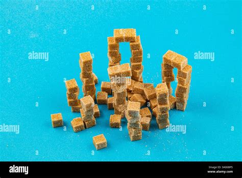 Various Structures Created With Brown Sugar Cubes On A Bright Blue