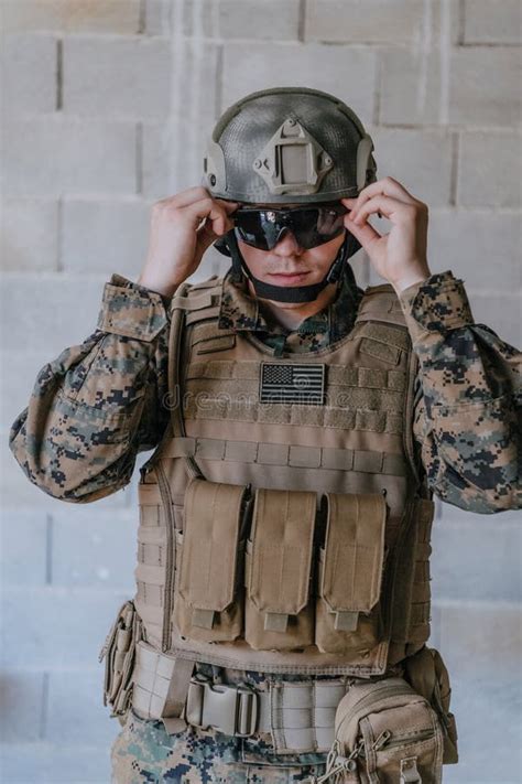 Soldier Preparing Tactical Protective And Communication Gear For Action